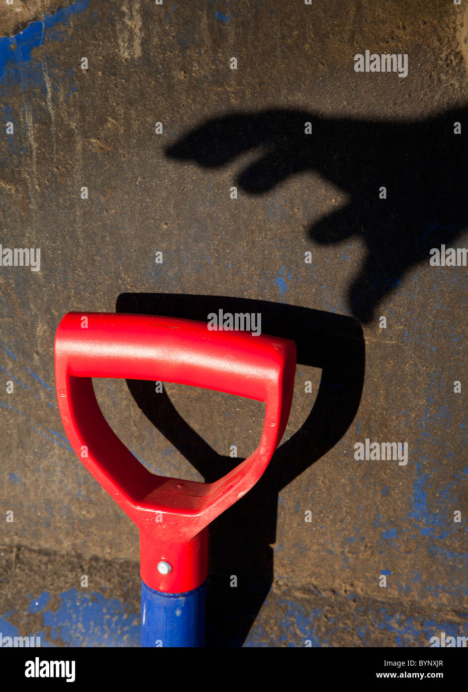 Spade and a shadow image of a hand Stock Photo - Alamy