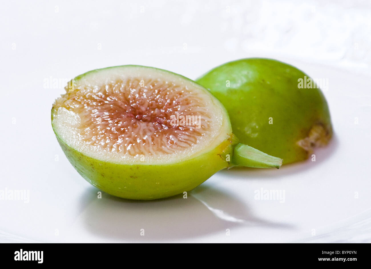 Fig half green ripe white background fruit food Stock Photo - Alamy