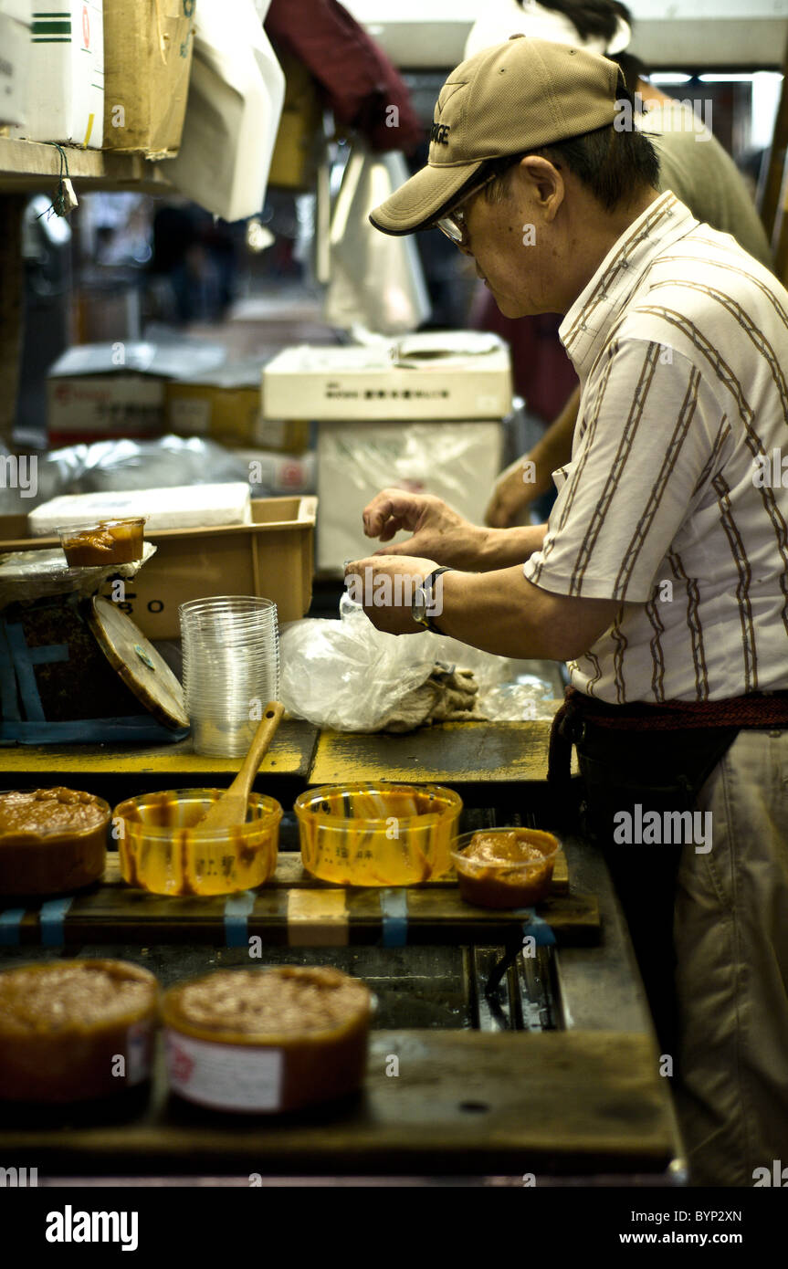 Stand owner at Tsukiji fish market Stock Photo - Alamy