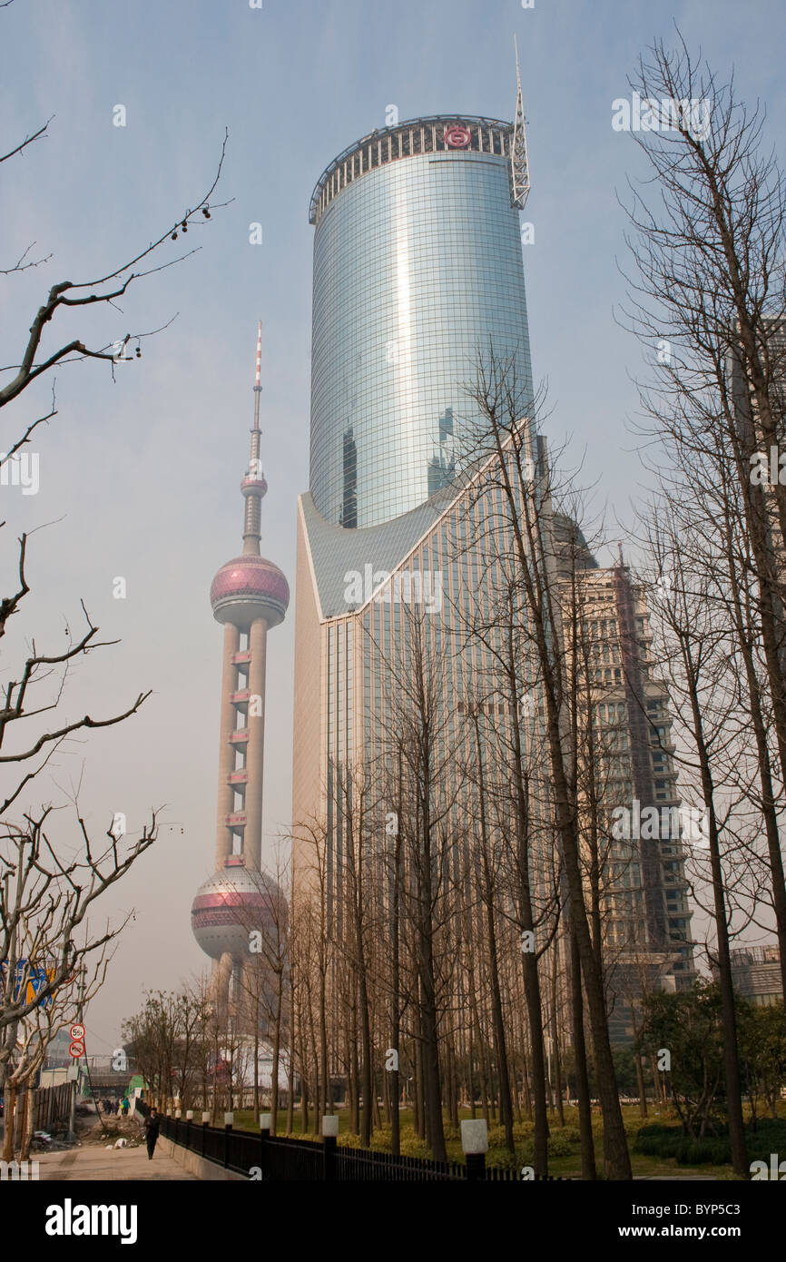Tall office building with the Oriental Pearl Tower Stock Photo - Alamy