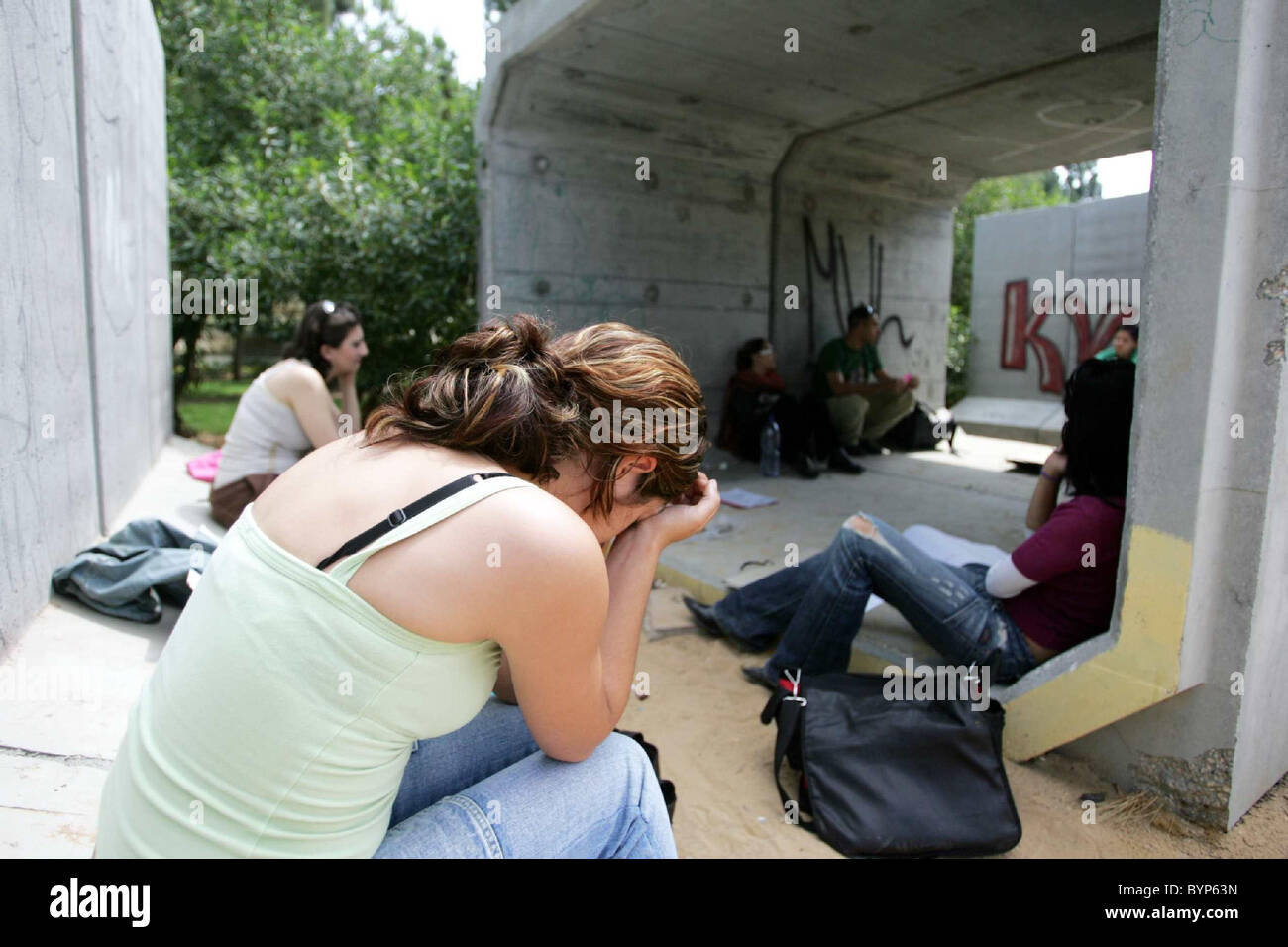 Students sit in makeshift shelters after a class is hit by a Quassam ...