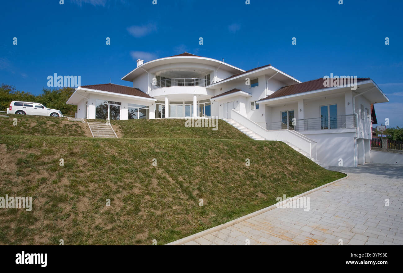 Modern house exteriors during day and night Stock Photo - Alamy