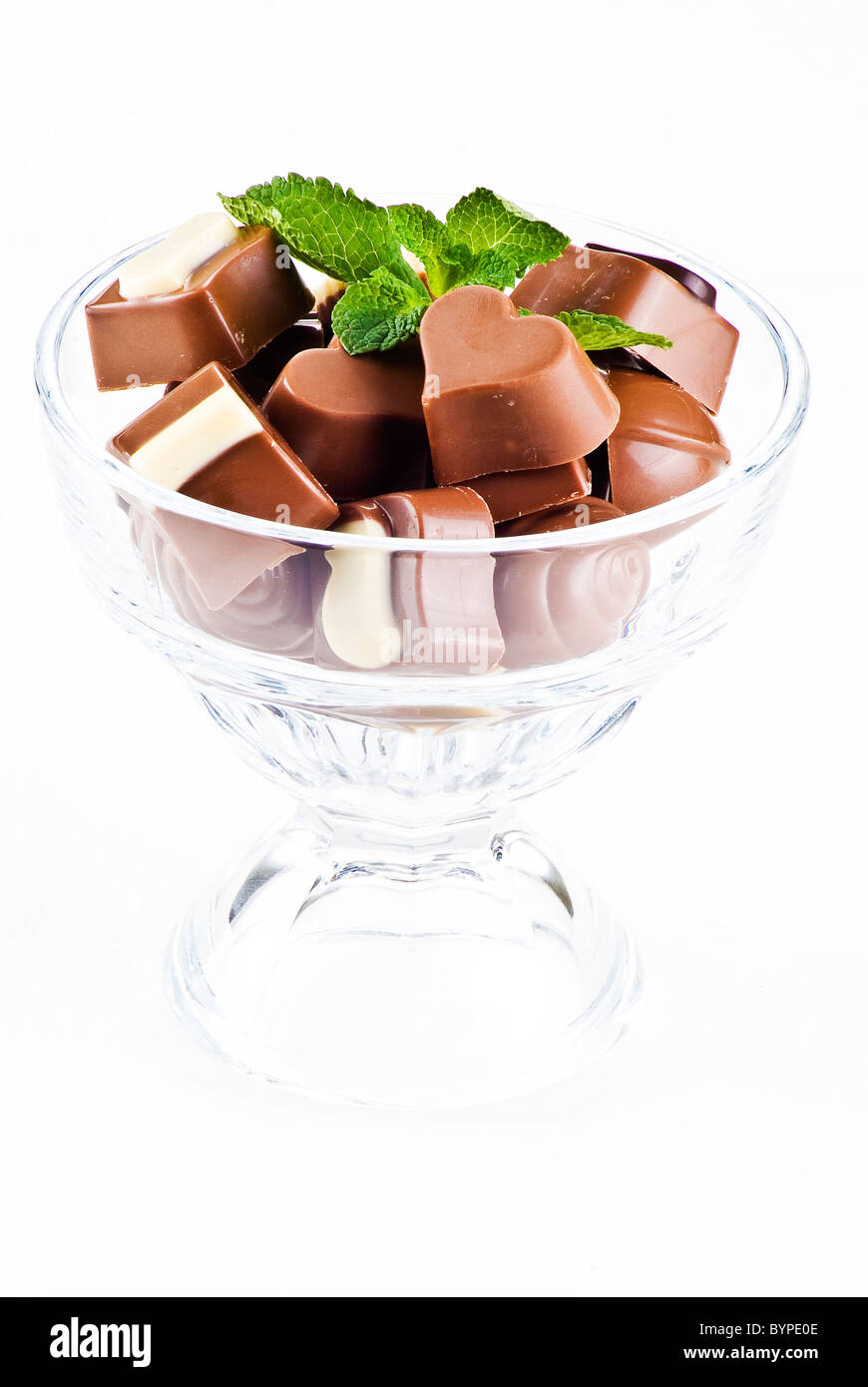 Glass bowl of assorted chocolates and mint Stock Photo - Alamy