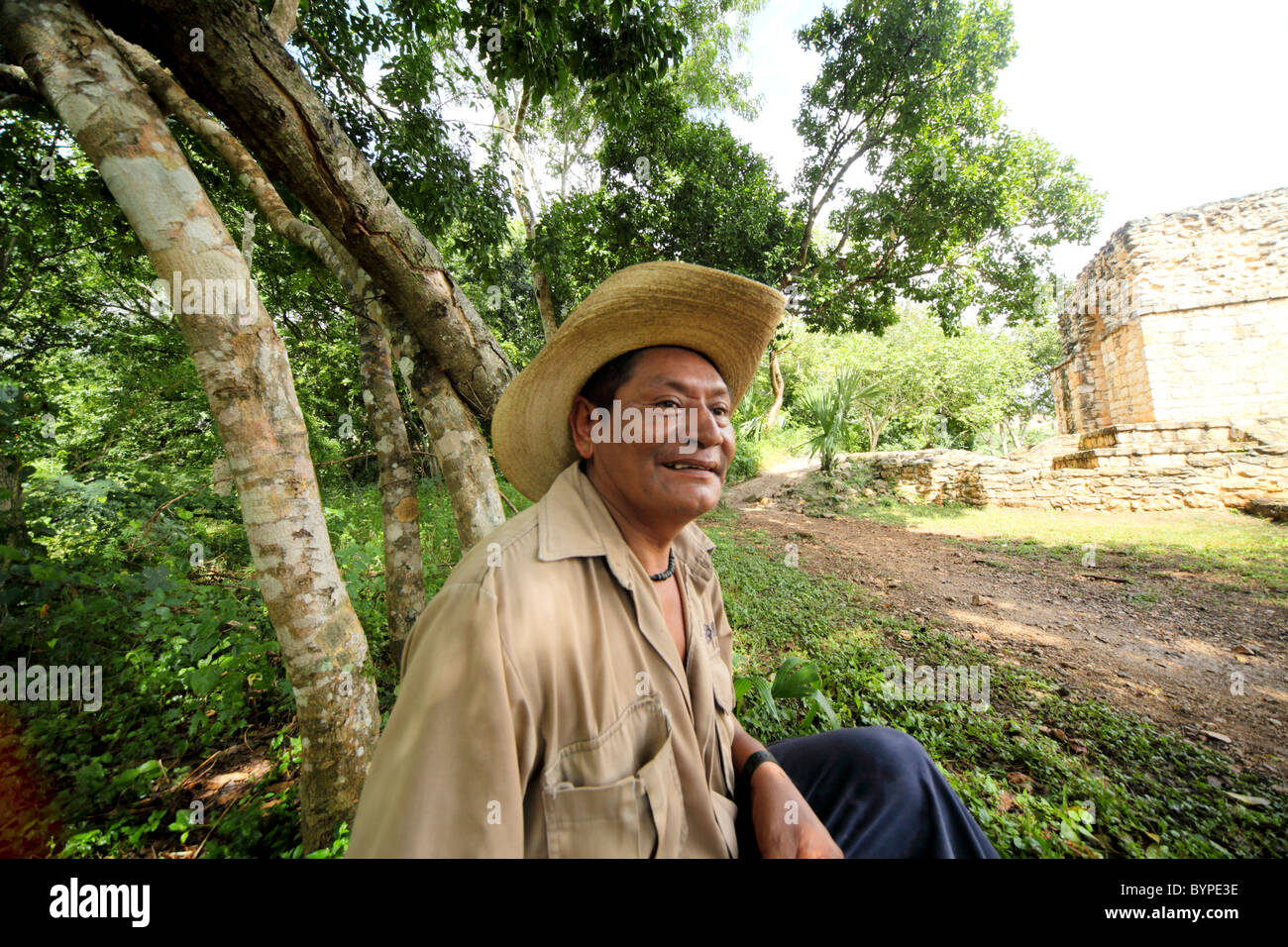 A MEXICAN SITTING NEAR THE ANCIENT MAYAN RUINS AT EK BALAM, YUCATAN ...