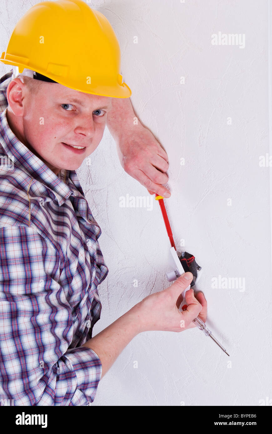 Young Electrician fitting new light switch Stock Photo - Alamy