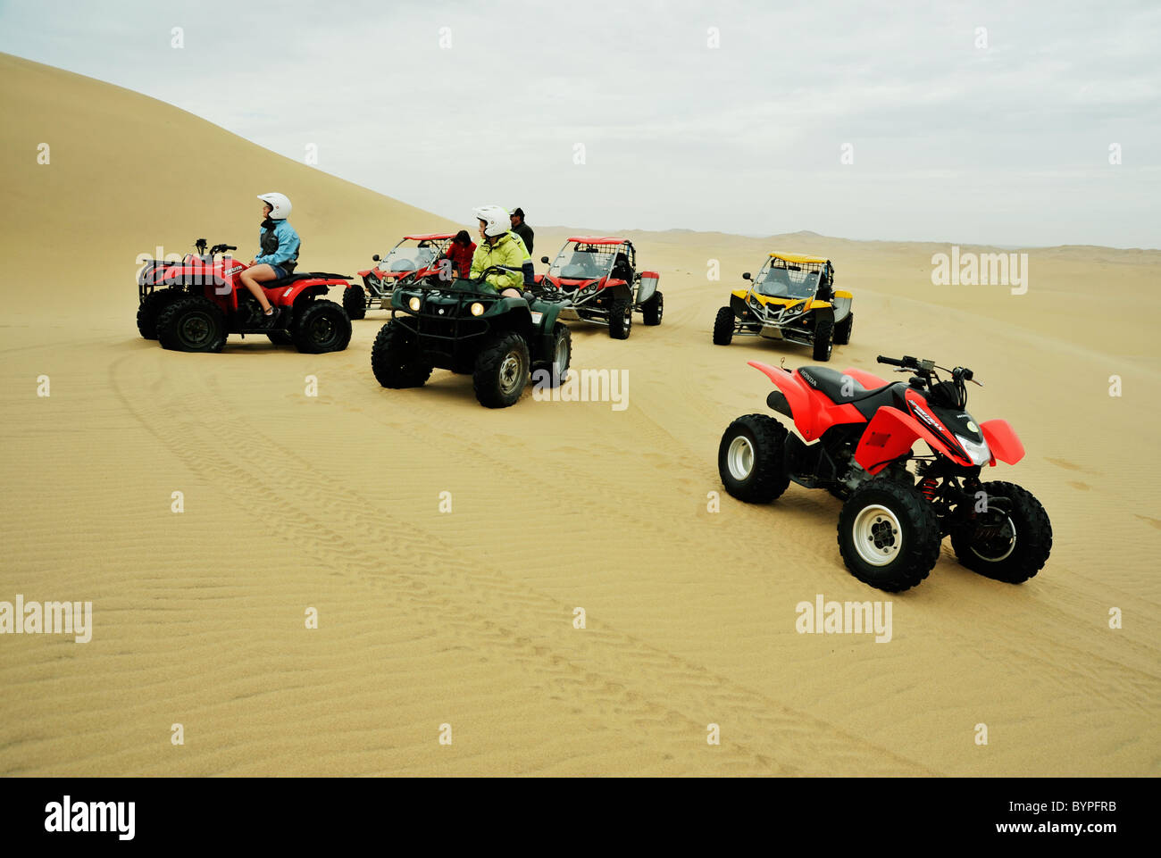 Group, people, 4x4 ATVs standing on sand dune, desert adventure tour ...