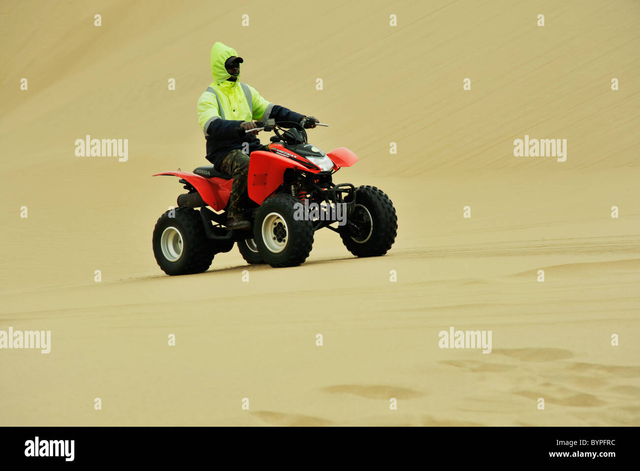 Adult man reflective clothing, riding 4x4 ATV quad bike, desert ...