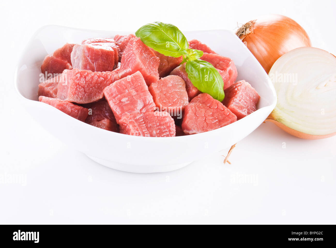 Diced beef with onion over white background Stock Photo - Alamy
