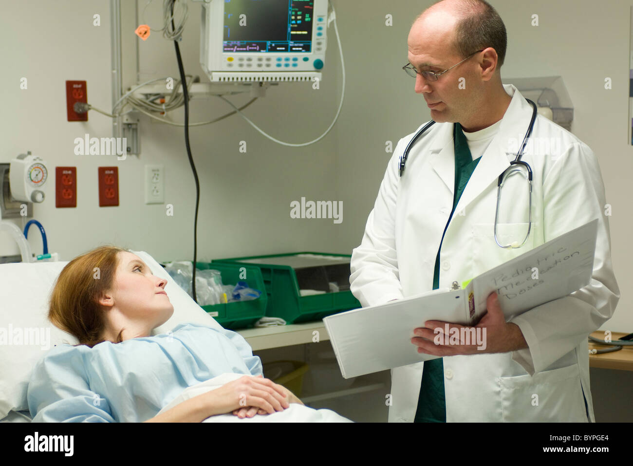 Doctors discussing patient chart over hi-res stock photography and ...