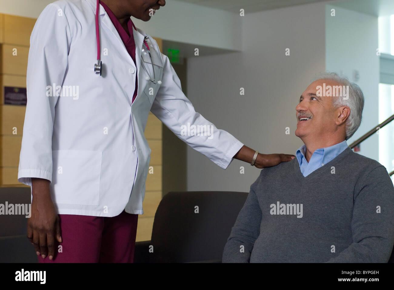 Doctor reassuring patient in waiting room Stock Photo - Alamy