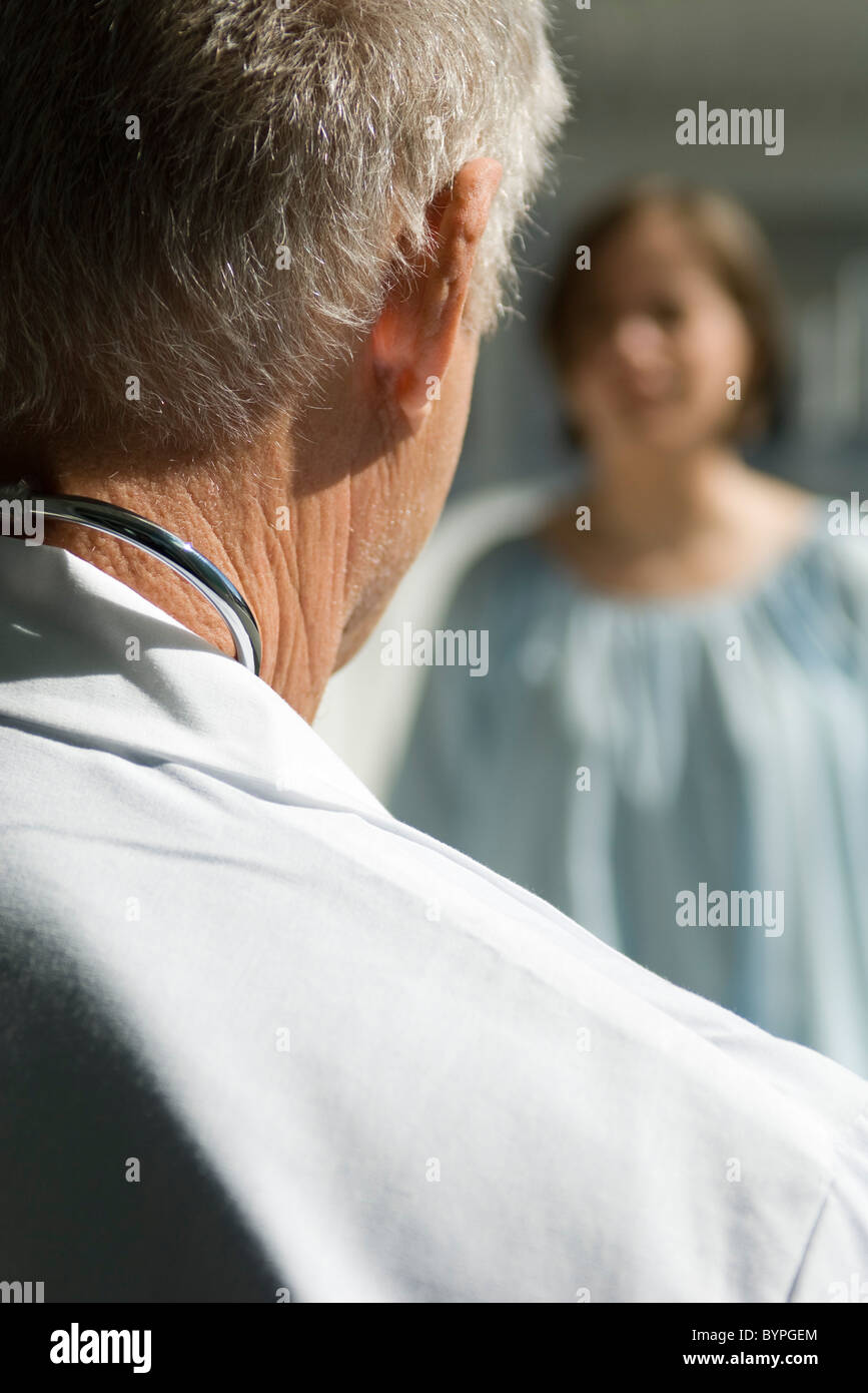 Doctor talking with patient, over the shoulder view Stock Photo - Alamy