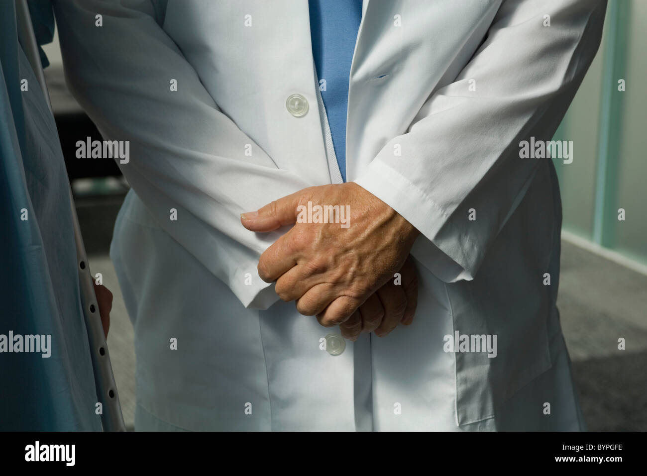 Doctor's clasped hands Stock Photo - Alamy