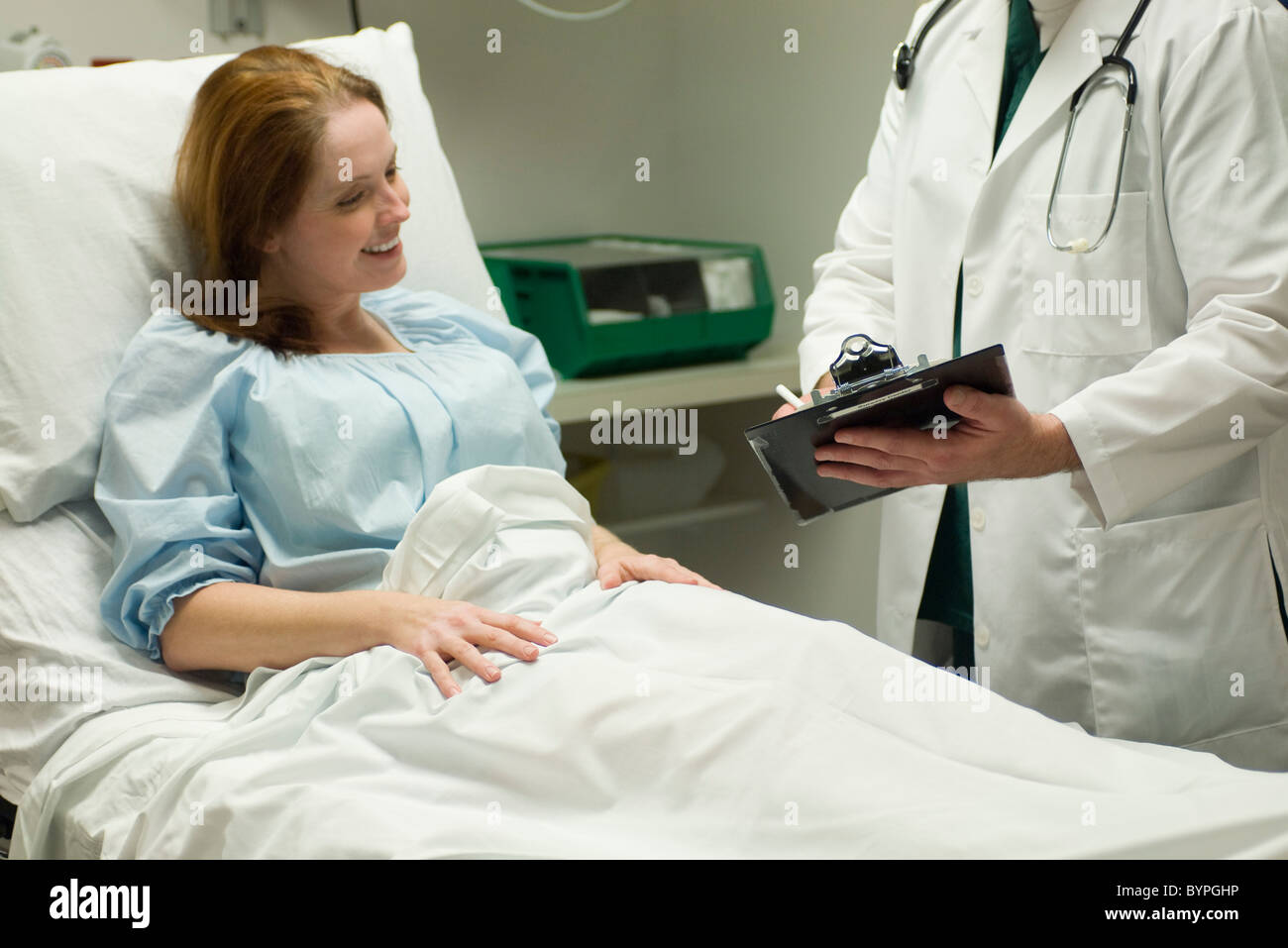 Doctors discussing patient chart over hi-res stock photography and ...