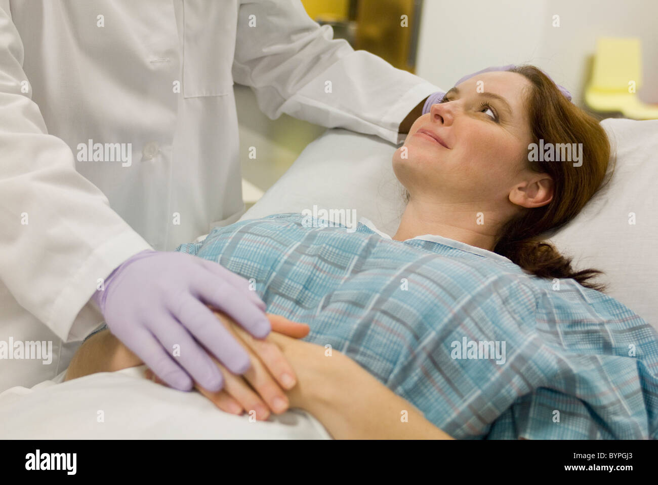 Doctor comforting female patient Stock Photo - Alamy