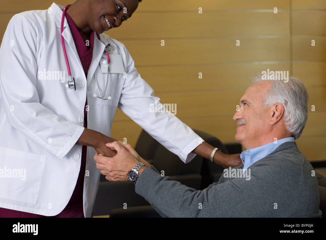 Doctor reassuring patient in waiting room Stock Photo - Alamy