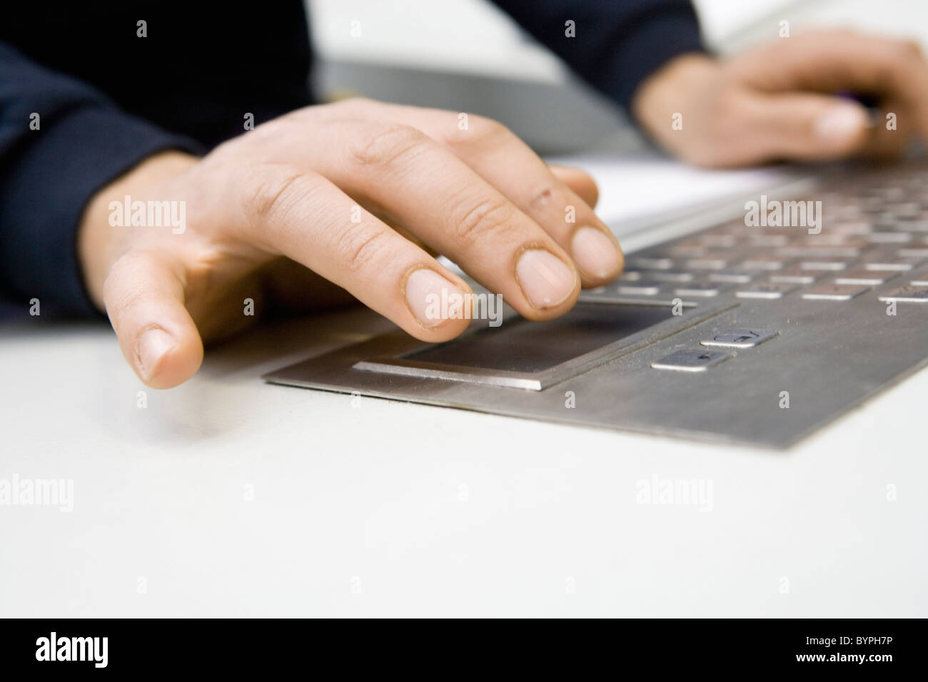 Hands using keyboard on control panel Stock Photo - Alamy