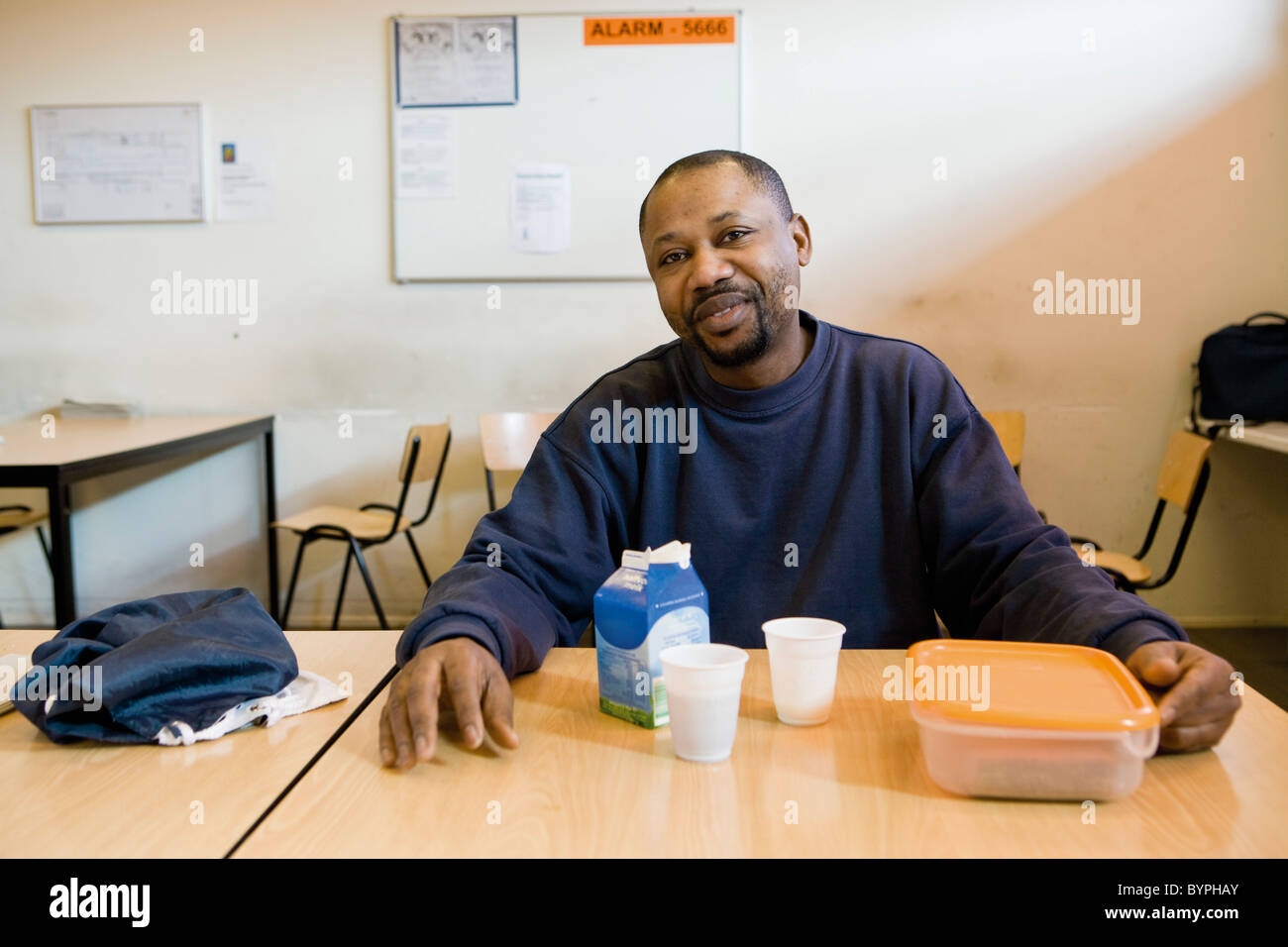 Factory worker having lunch in breakroom Stock Photo - Alamy