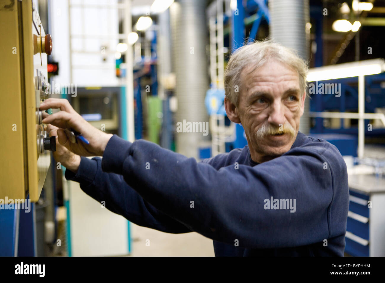 Textile worker regulating machine in carpet tile factory Stock Photo ...