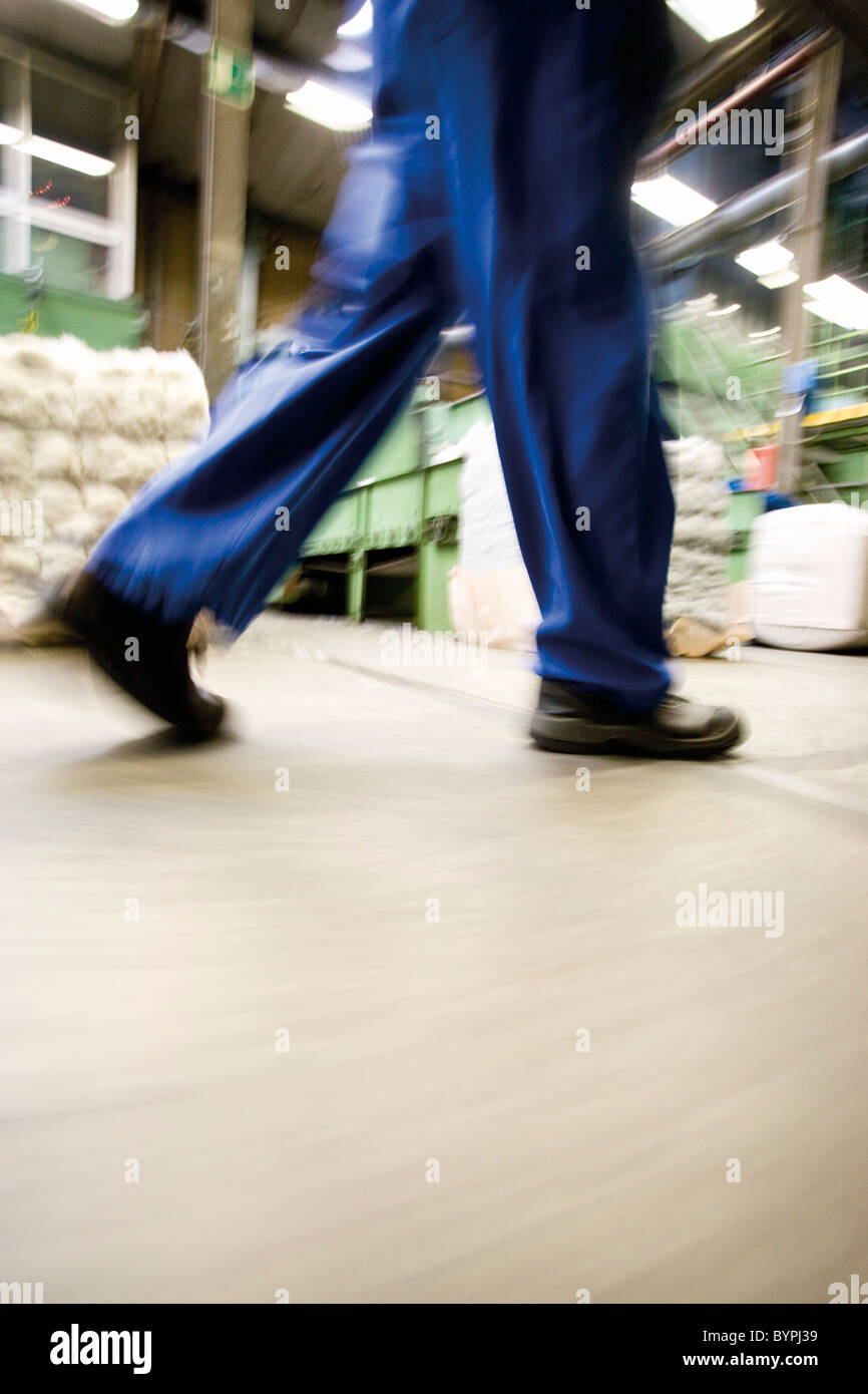 Factory worker walking, low section Stock Photo - Alamy