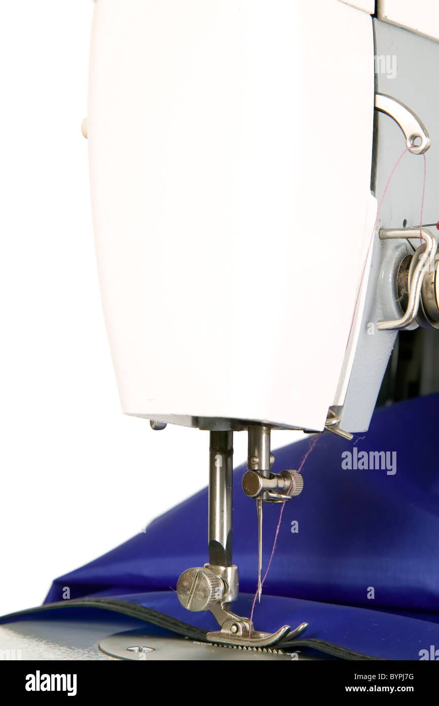 Sewing machine is stitching piece of blue fabric Stock Photo - Alamy