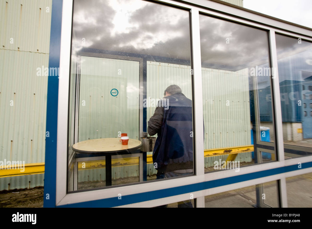 Man in outdoor smoking area Stock Photo - Alamy