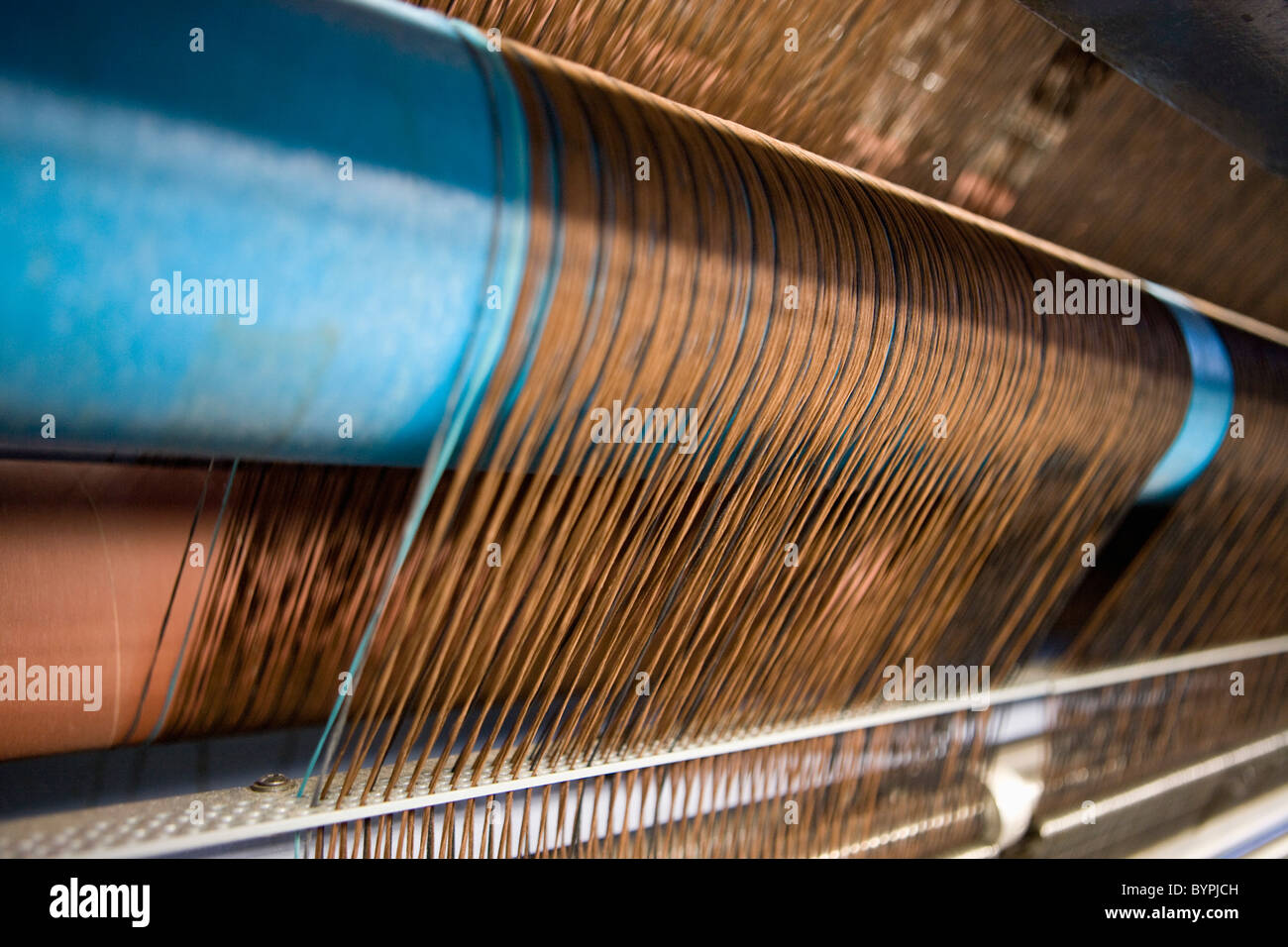 Loom weaving carpet in carpet tile factory Stock Photo - Alamy