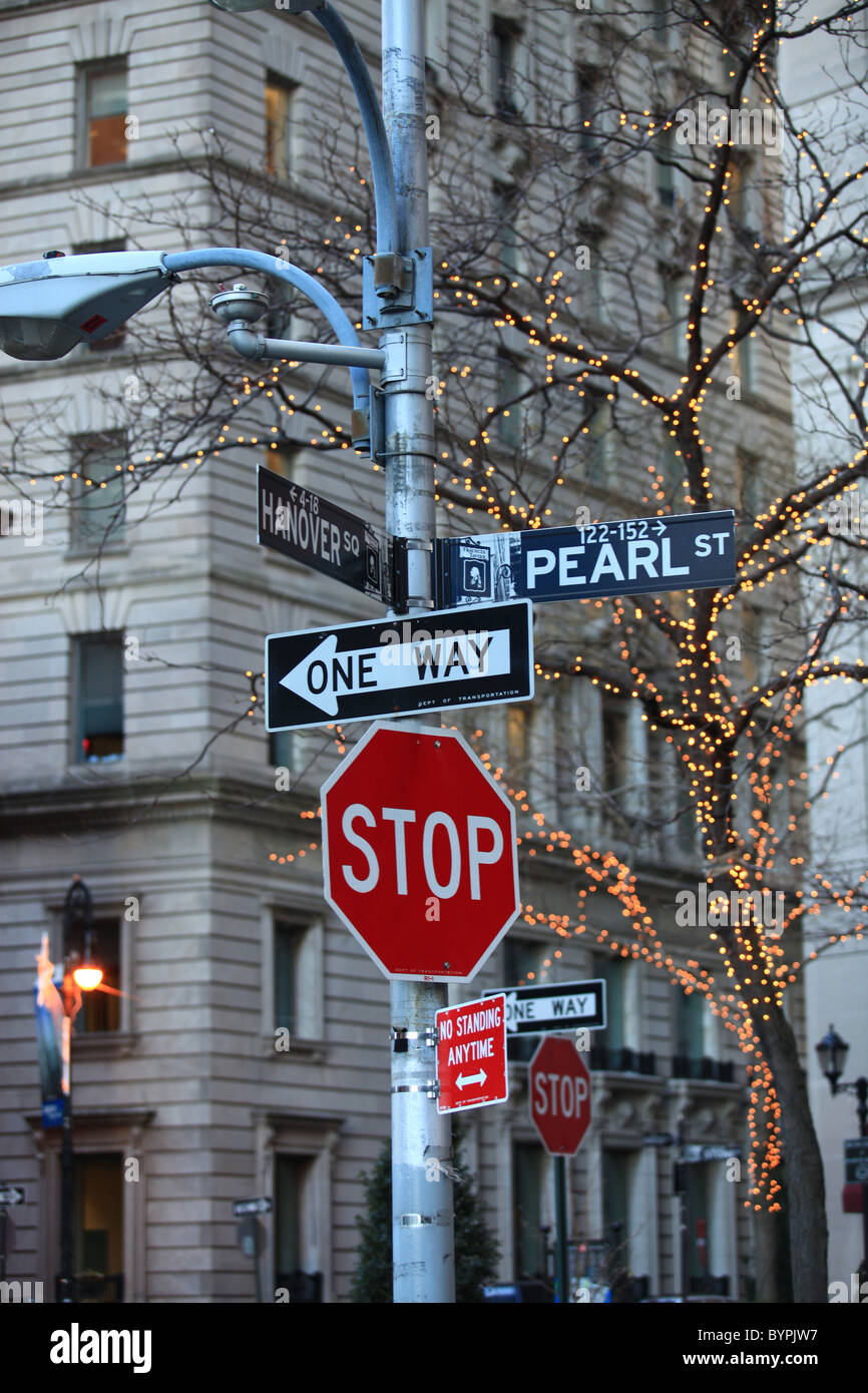 Stop sign and oneway sign at an intersection at Pearl St in New York ...