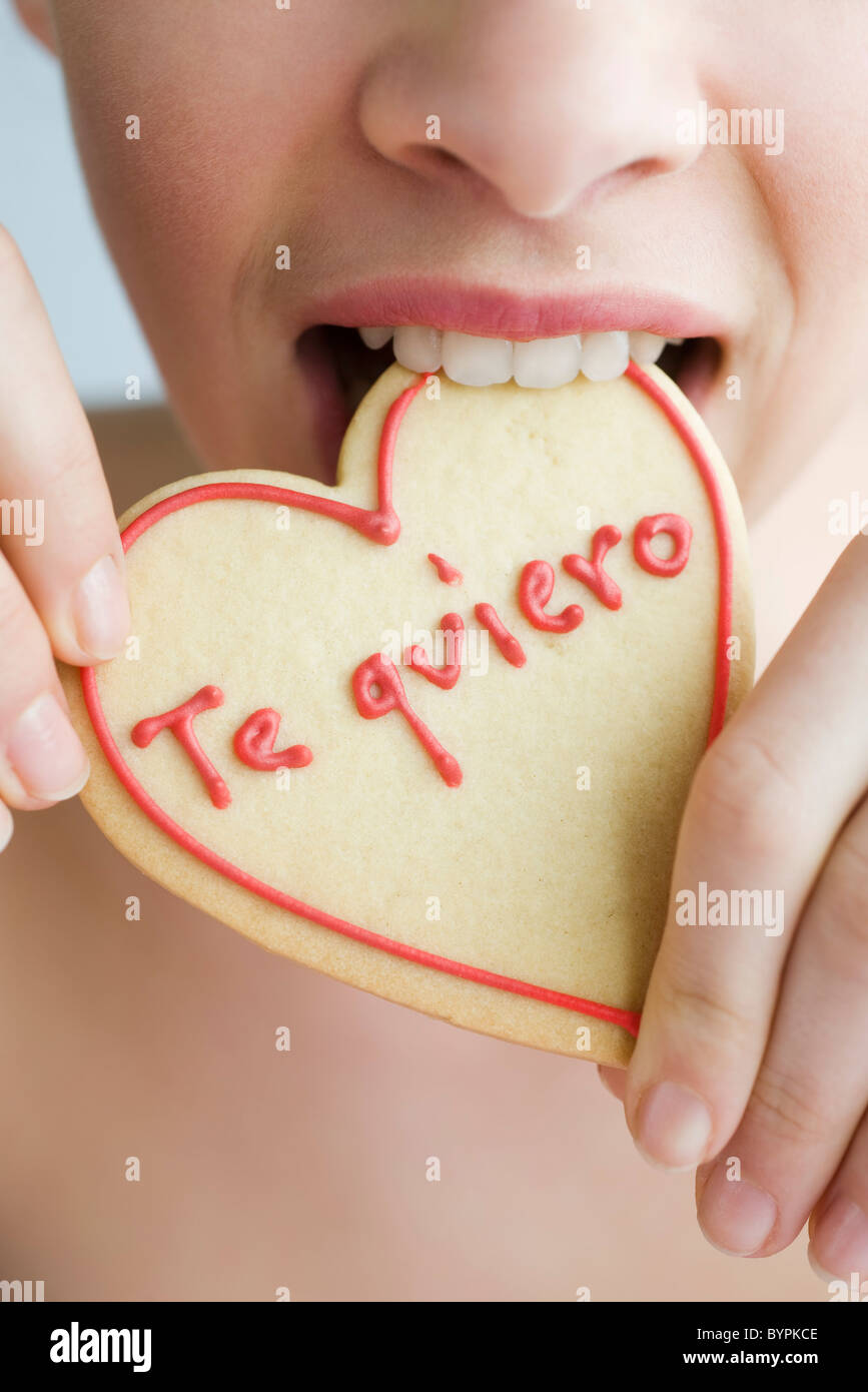 Eating heart-shaped cookie Stock Photo - Alamy