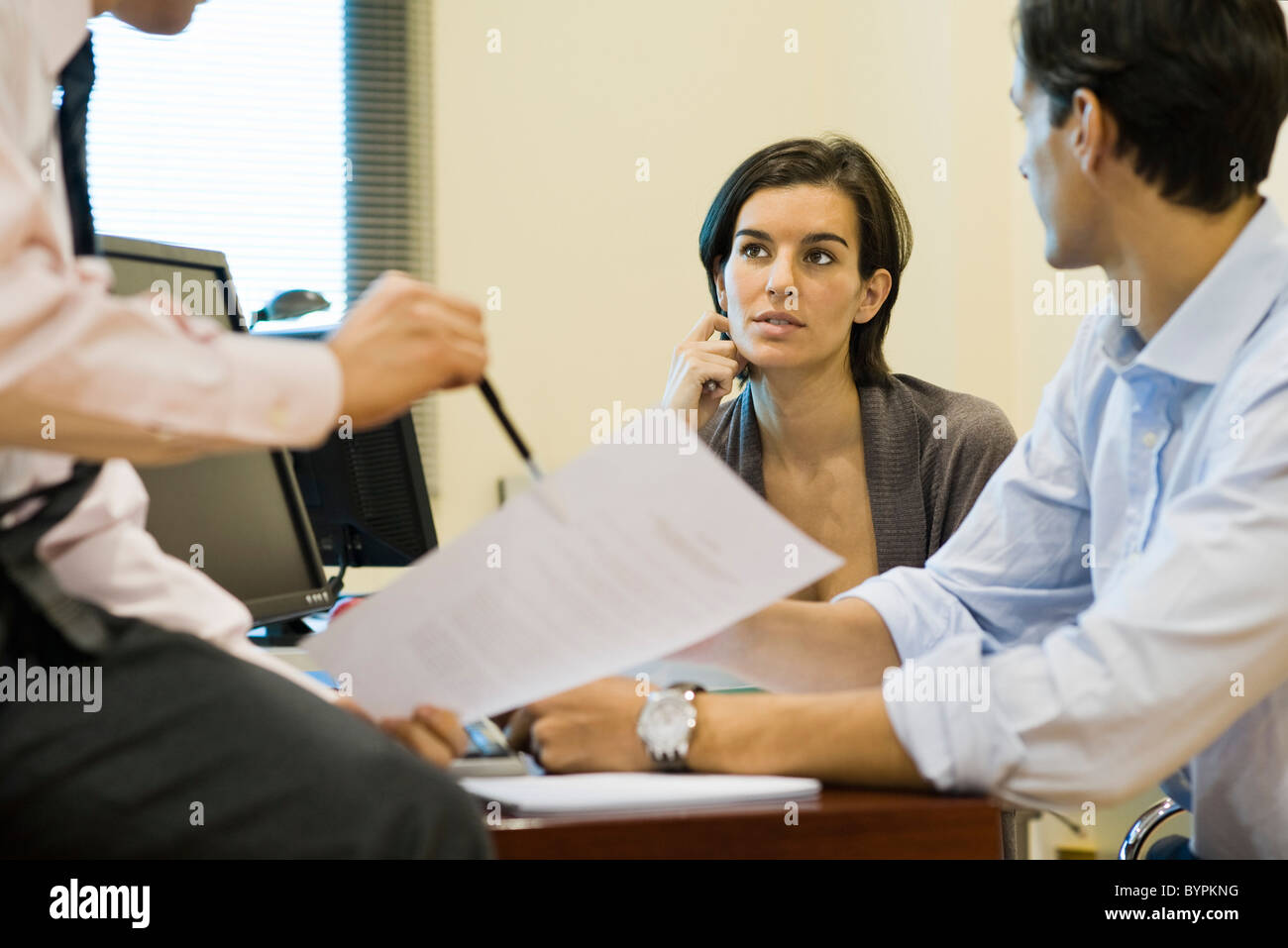Executives discussing document Stock Photo - Alamy