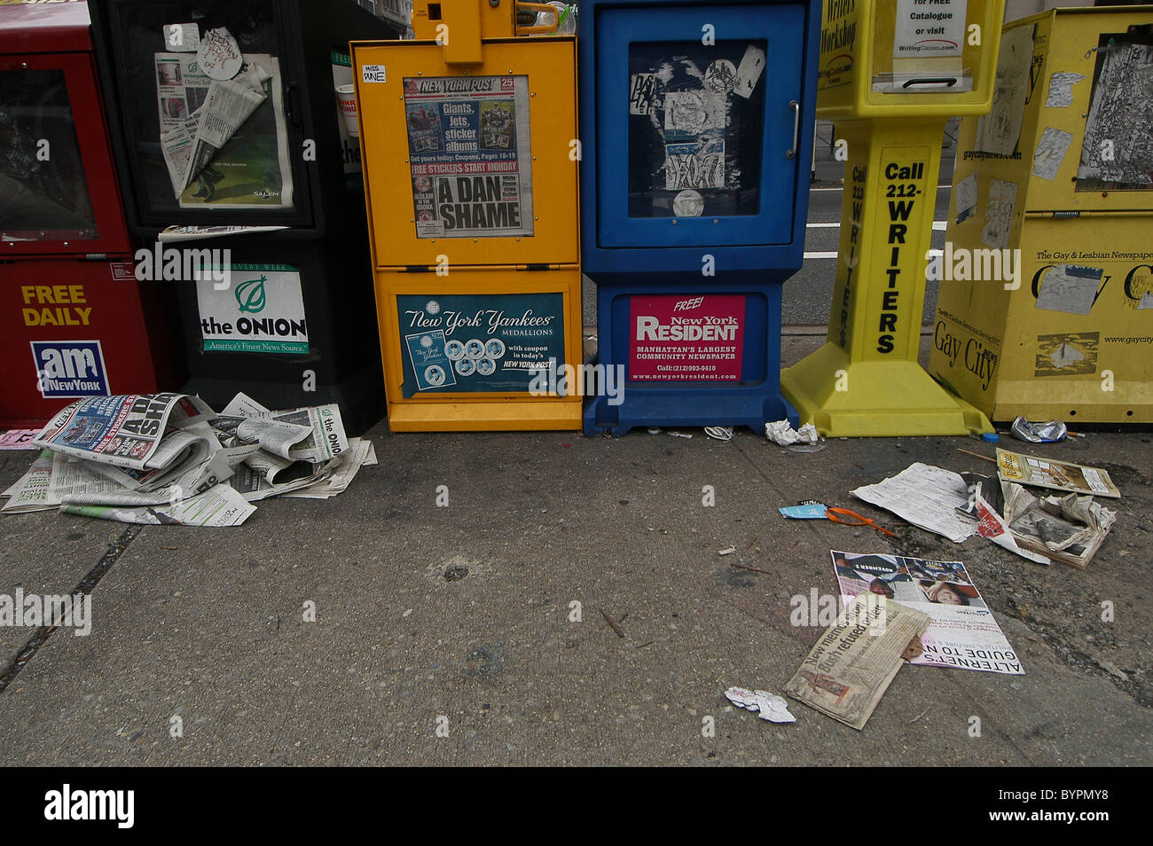 These discarded newspapers litter the street next to the automatic ...