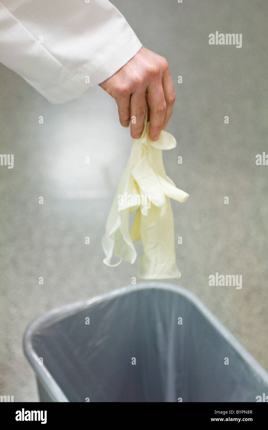 Throwing away disposable latex gloves Stock Photo - Alamy