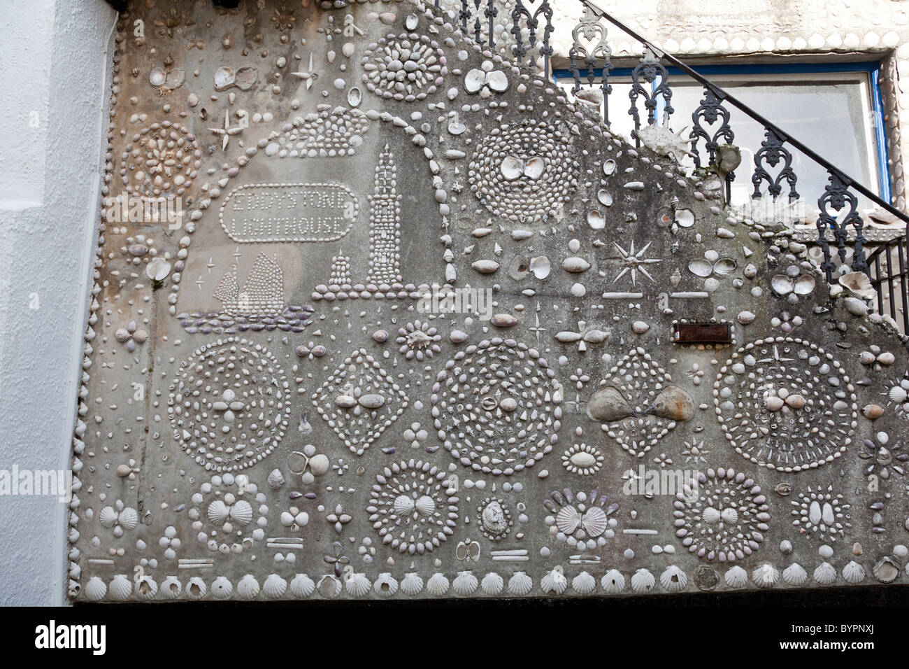 Decorative mural made of sea shells on a wall in Polperro, Cornwall ...