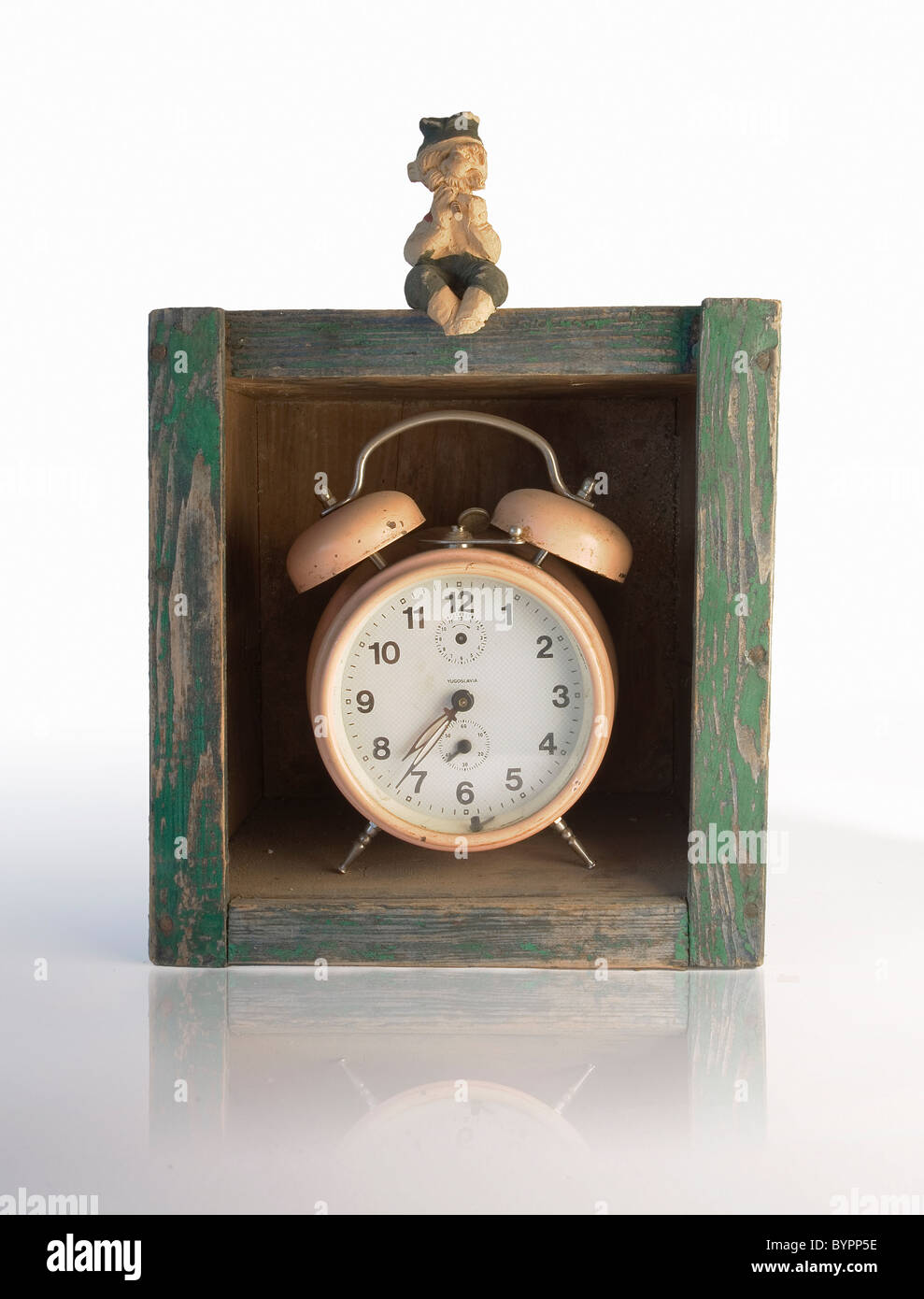 Old clock in a wooden box with souvenir of a man on the top Stock Photo ...