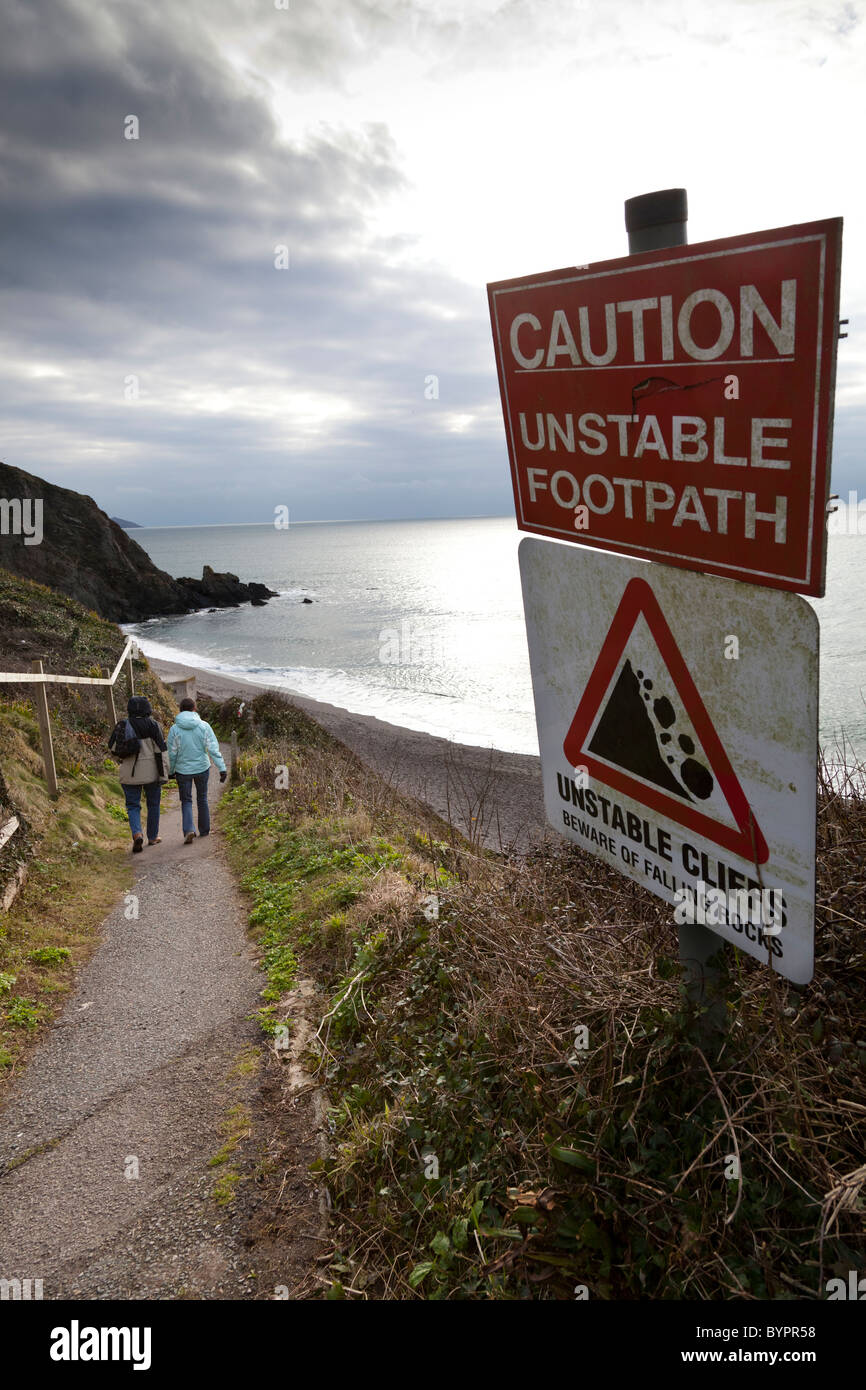 People walking past warning sign hi-res stock photography and images ...
