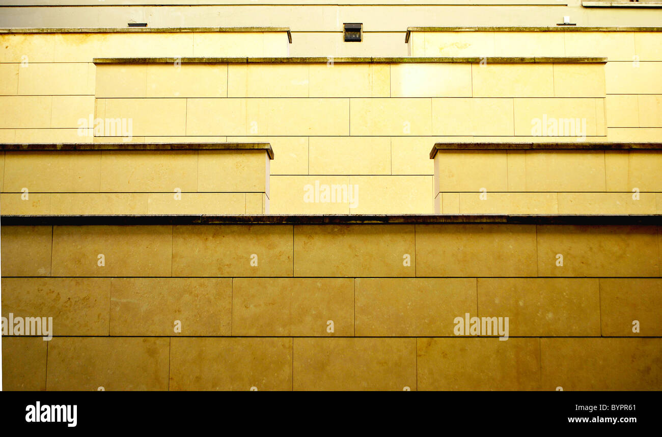 modern building with stone slabs, blue sky background Stock Photo - Alamy