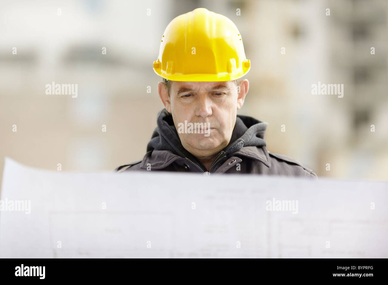 real builder with blueprints on construction site, natural light, focus ...