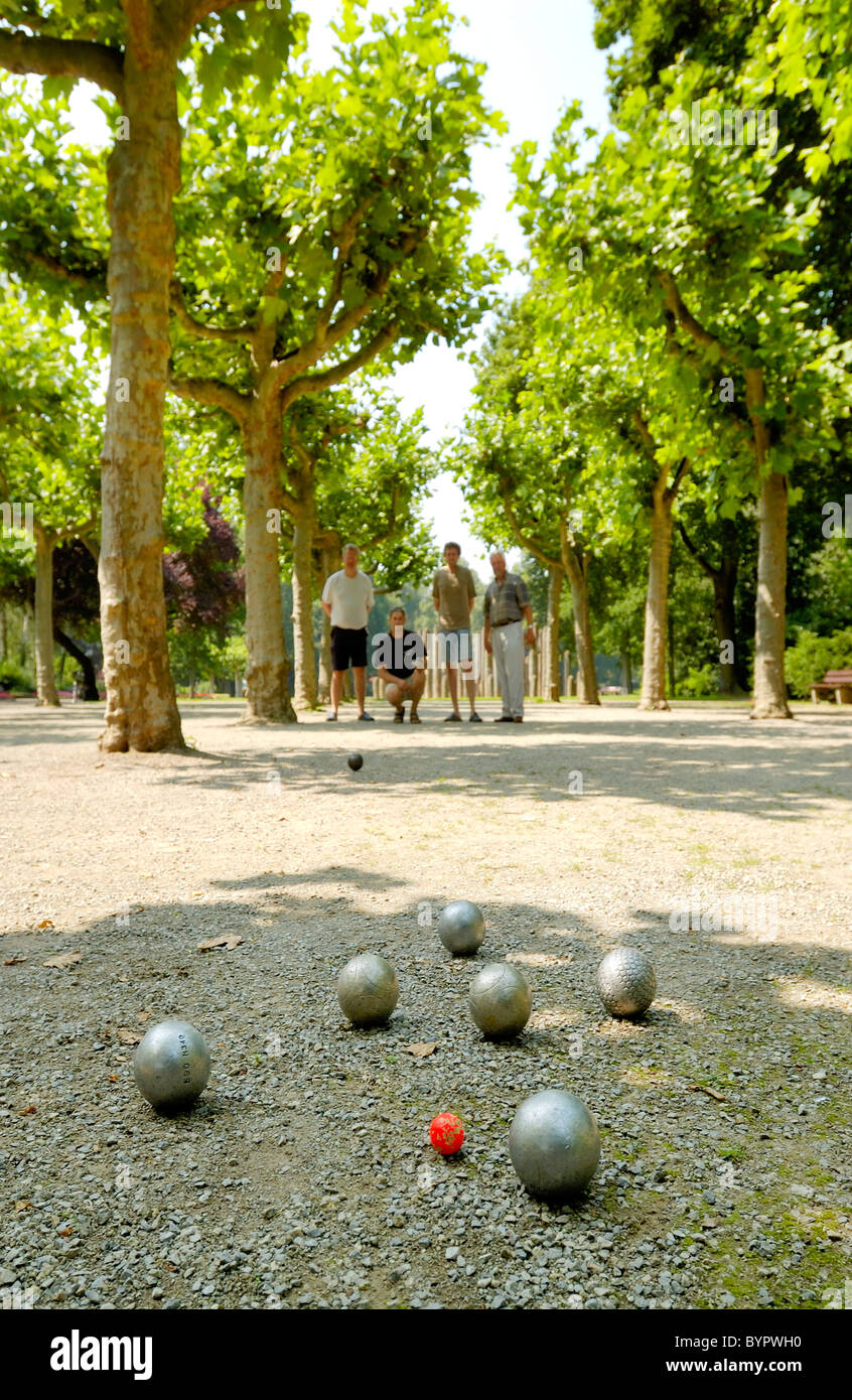 boules balls, four men diffuse behind, petanque Stock Photo - Alamy