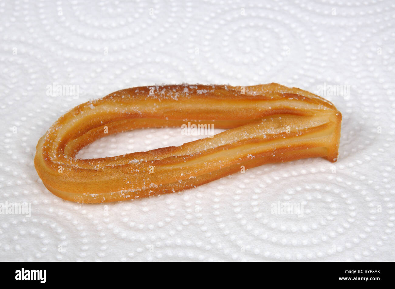 Single churro on kitchen towel Stock Photo - Alamy
