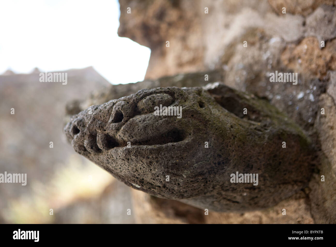 Etruscan mask decorating a house wall in Civita di Bagnoregio, Viterbo ...