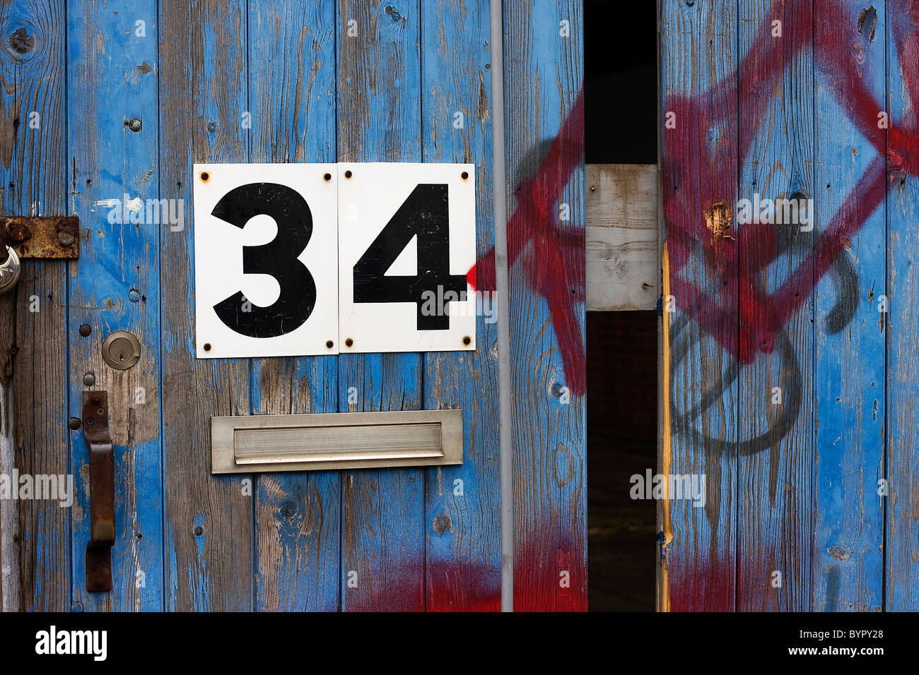 Detail of wooden door, blue, broken, number 34 Stock Photo - Alamy