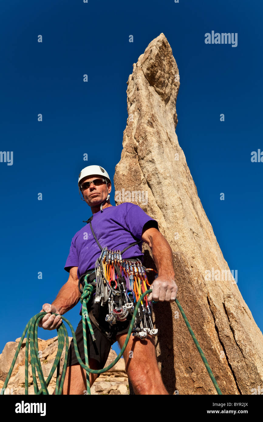 Male rock climber on the summit of a pinnacle Stock Photo - Alamy