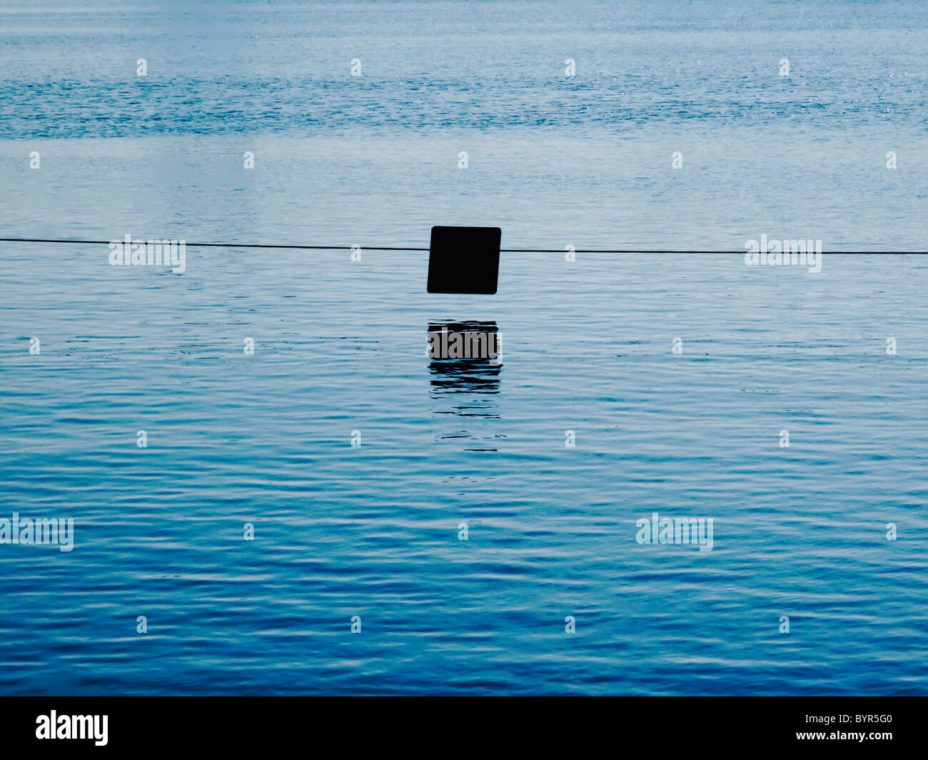 A still body of water with sign Stock Photo - Alamy