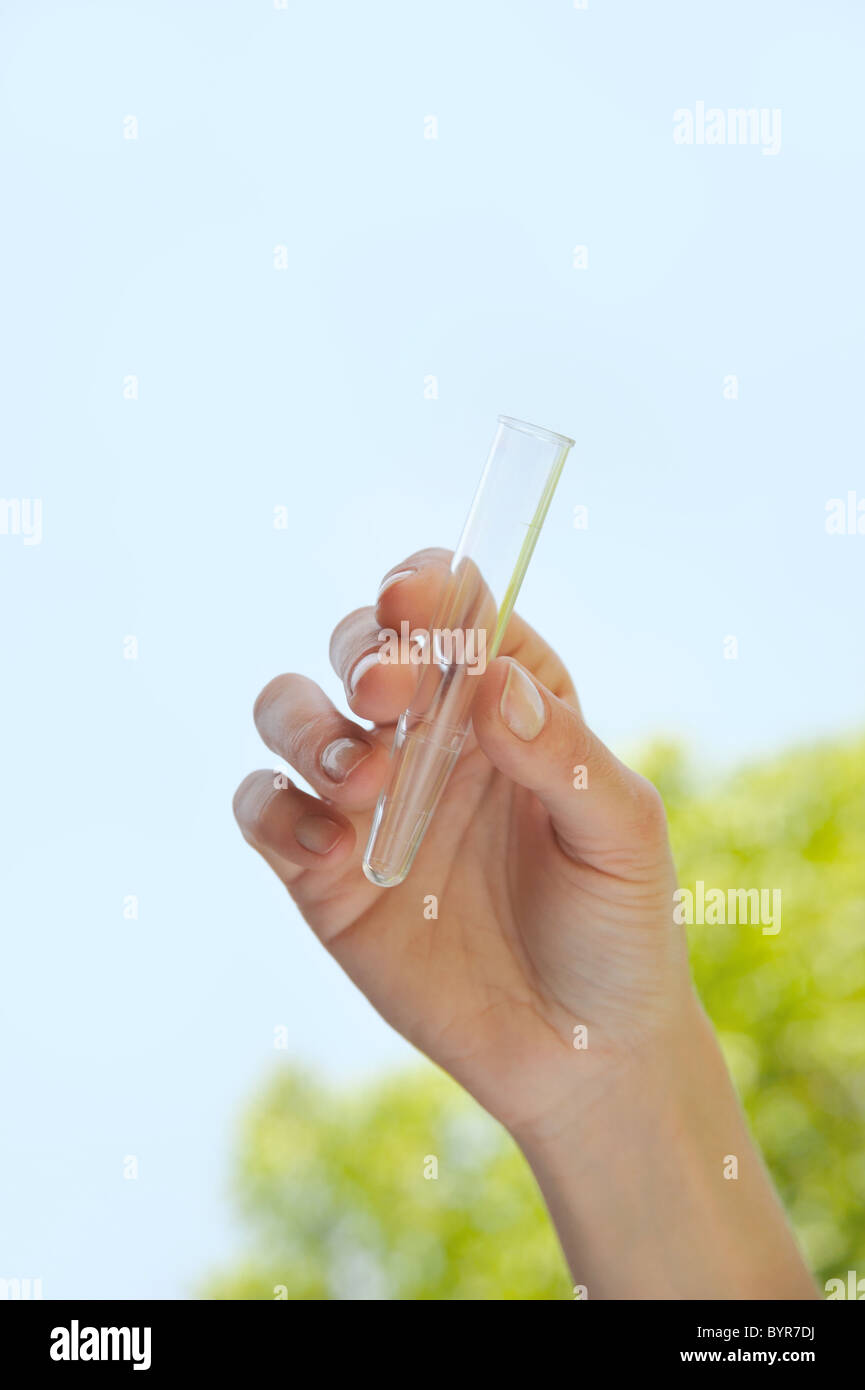 Hand holding empty test tube Stock Photo - Alamy