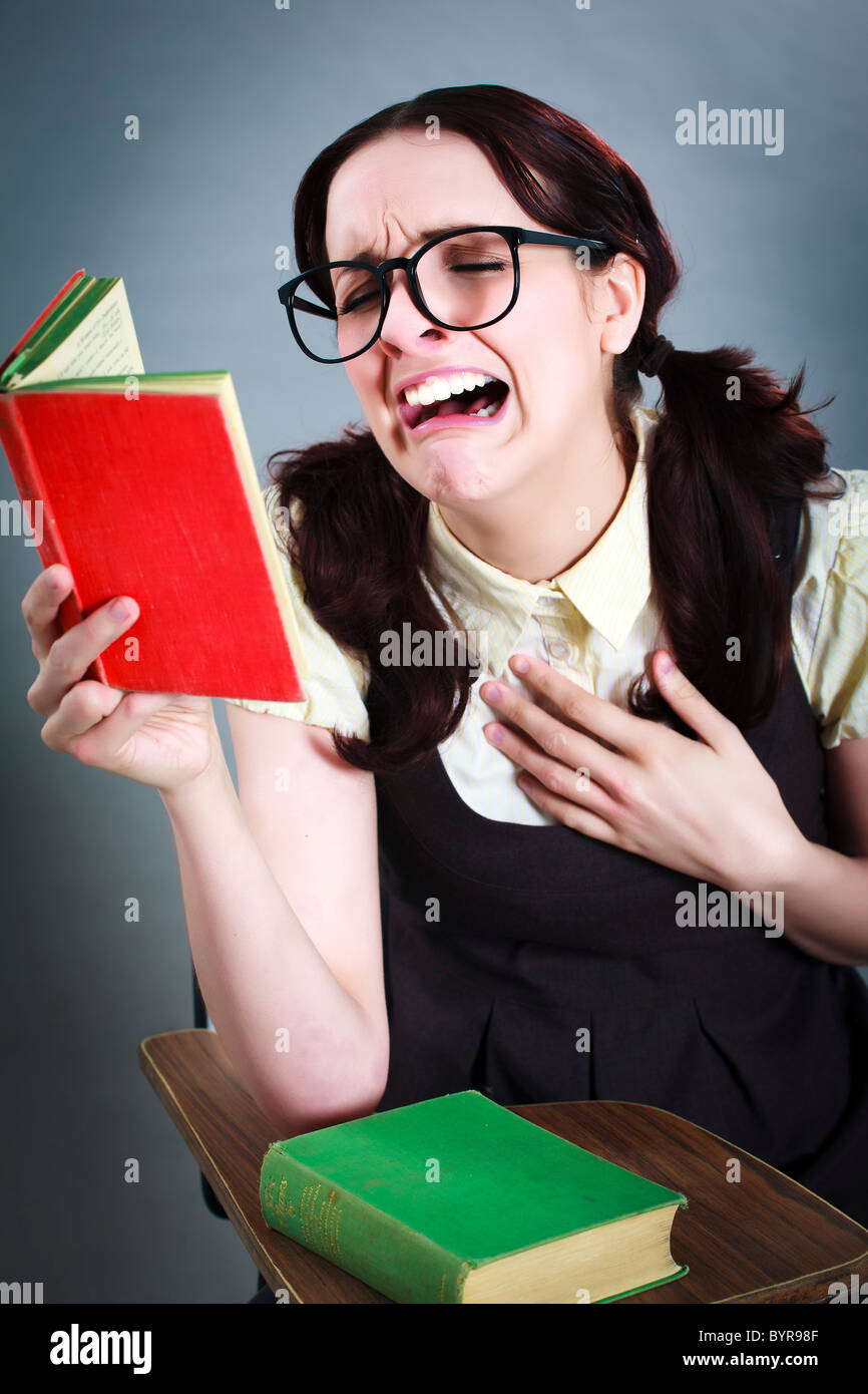 geeky girl reads her book whilst crying uncontrollably Stock Photo - Alamy