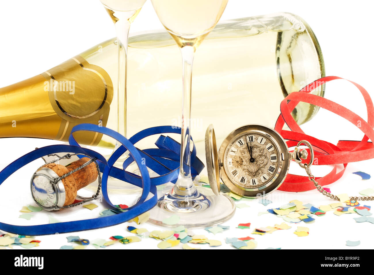 two glasses with champagne, old pocket watch, streamer, cork and ...