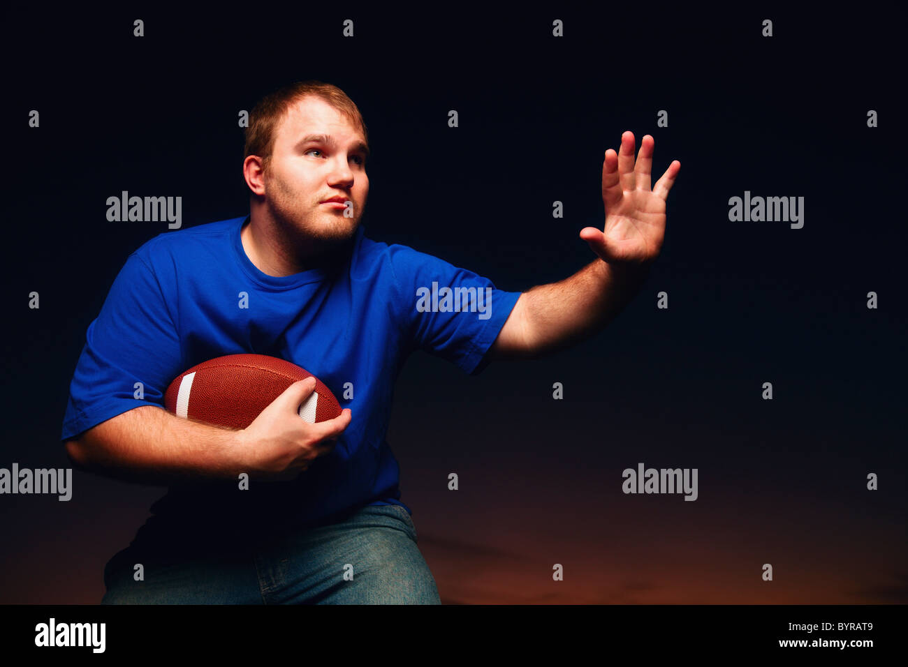 a young man playing football; wilmar, minnesota, united states of ...