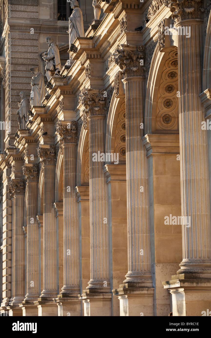 a series of stone pillars highlighted at sunset in the louvre courtyard ...