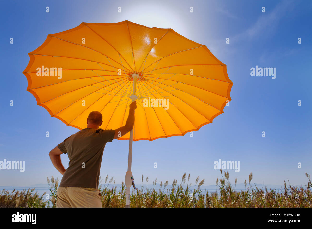 Yellow umbrella beach stand hi-res stock photography and images - Alamy