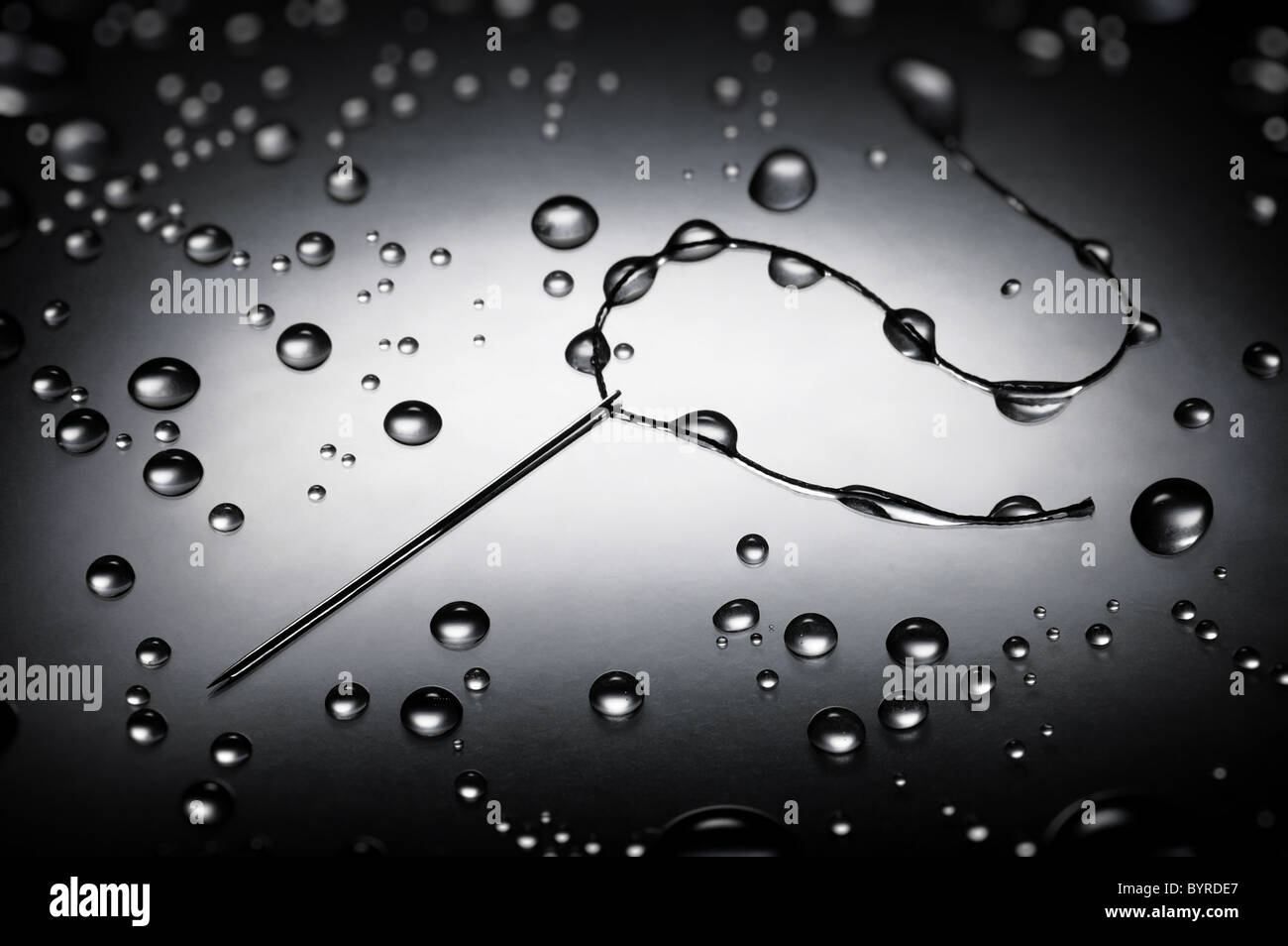Threaded needle , water drops background Stock Photo - Alamy