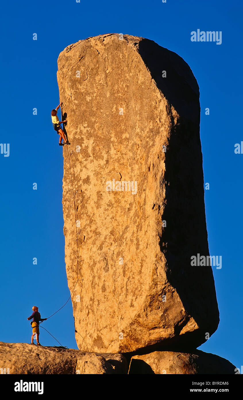 Team of climbers reaching the summit of a rock pinnacle Stock Photo - Alamy